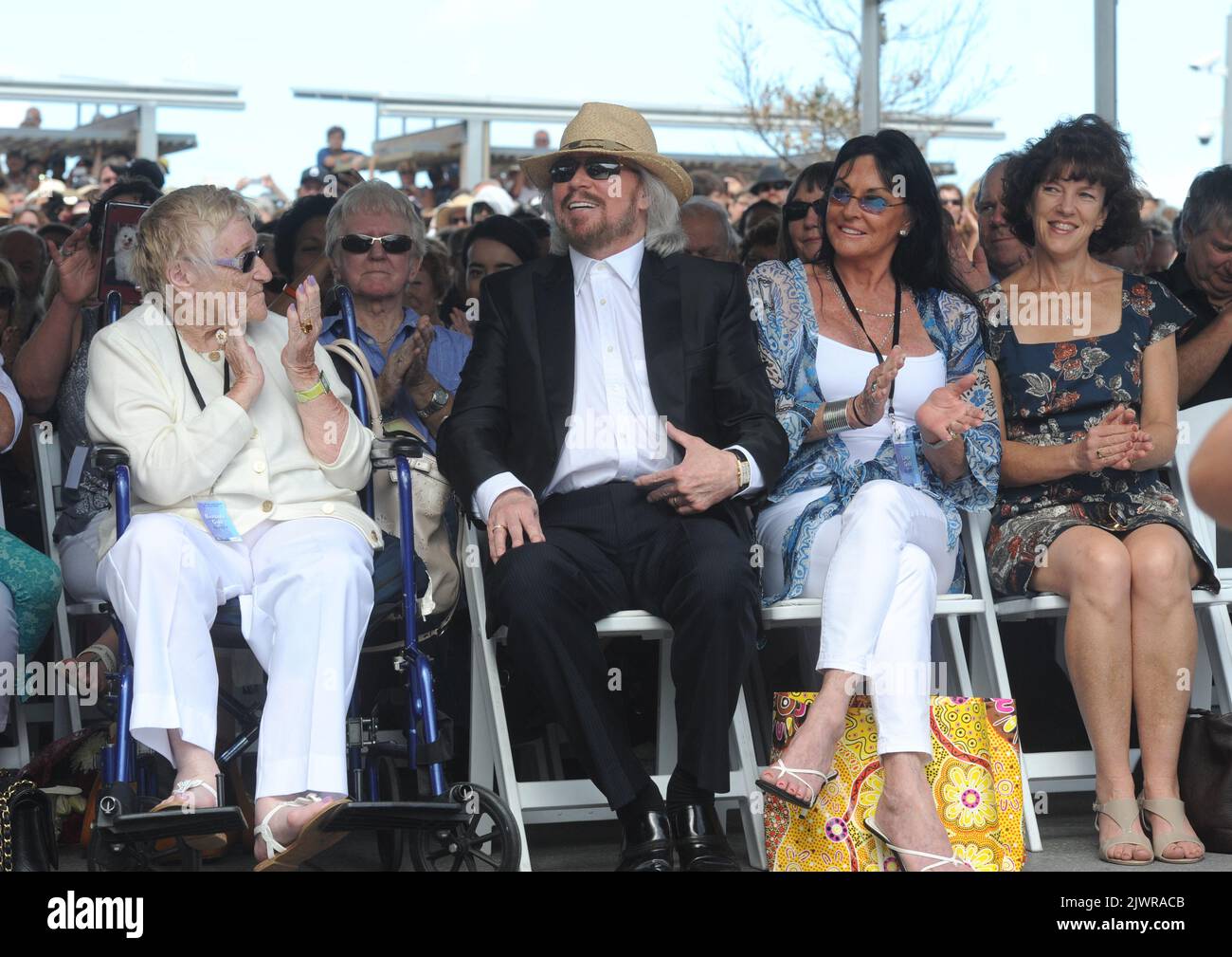 Barry Gibbs sits between his mother (left) and wife at the official ...