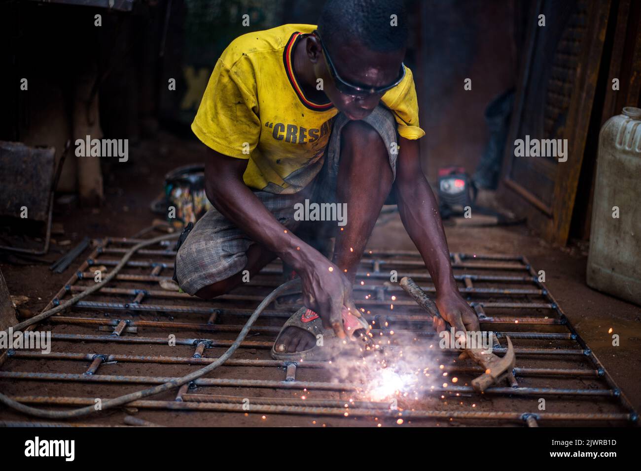 Man at work. A young welder observered at work in Lagos, NIGERIA, on ...