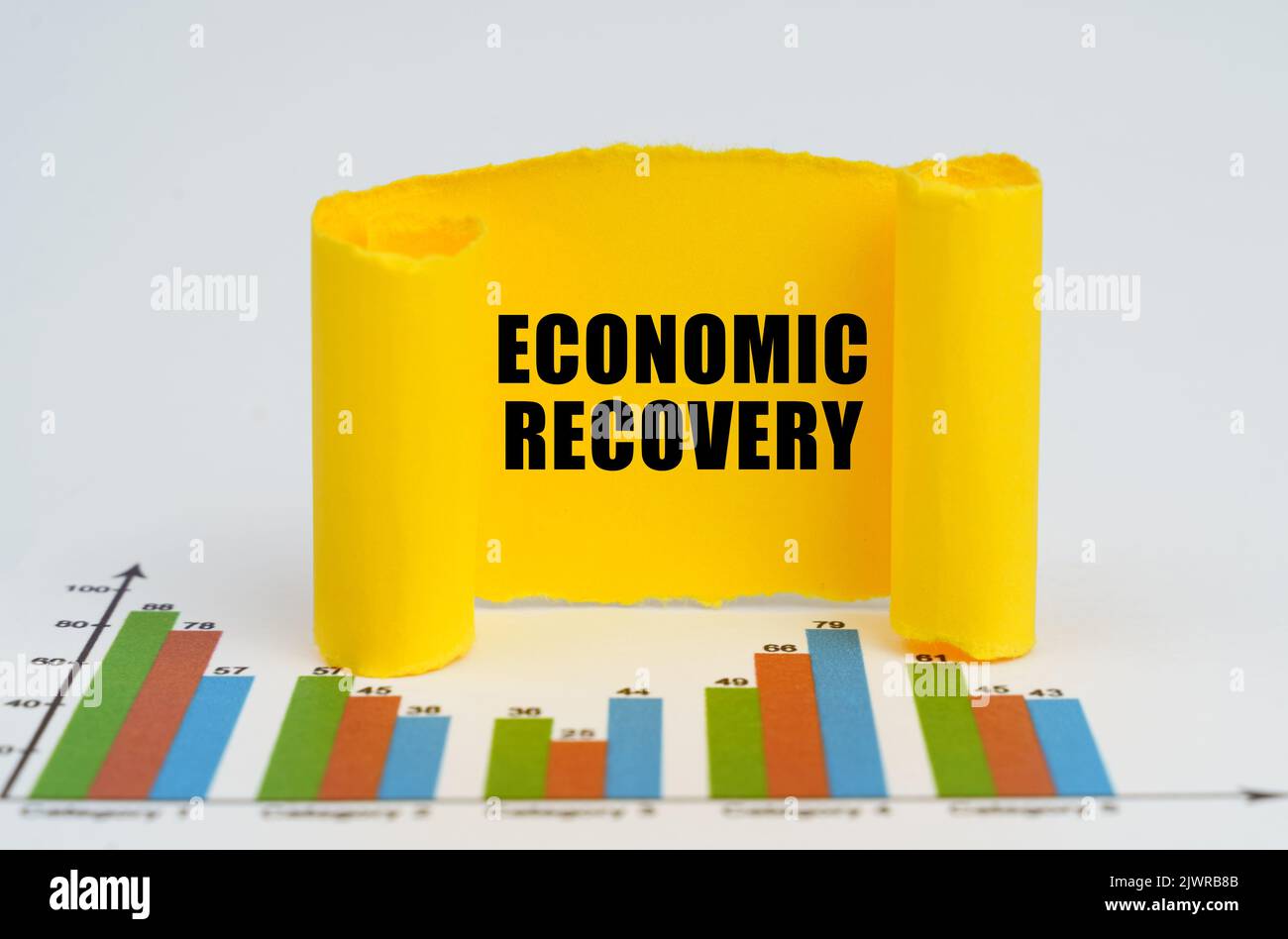 Business concept. Against the background of the graphs, a yellow paper ...