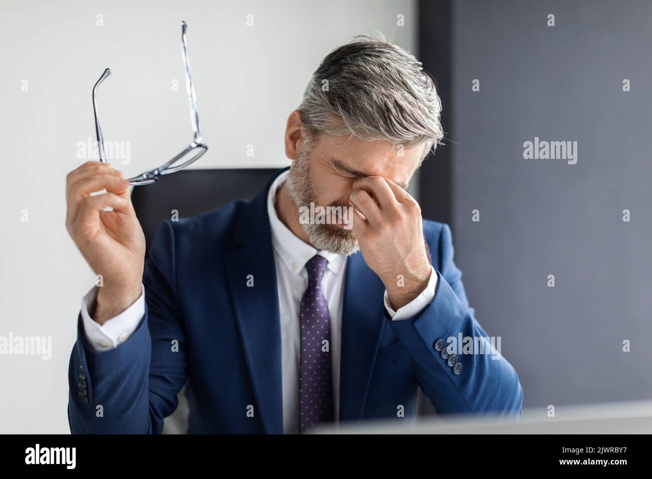Portrait Of Tired Middle Aged Businessman Suffering Eye Strain At ...