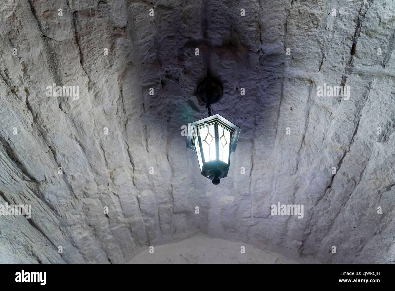 Vintage lantern hanging under the brick arch in the restaurant. Decor ...