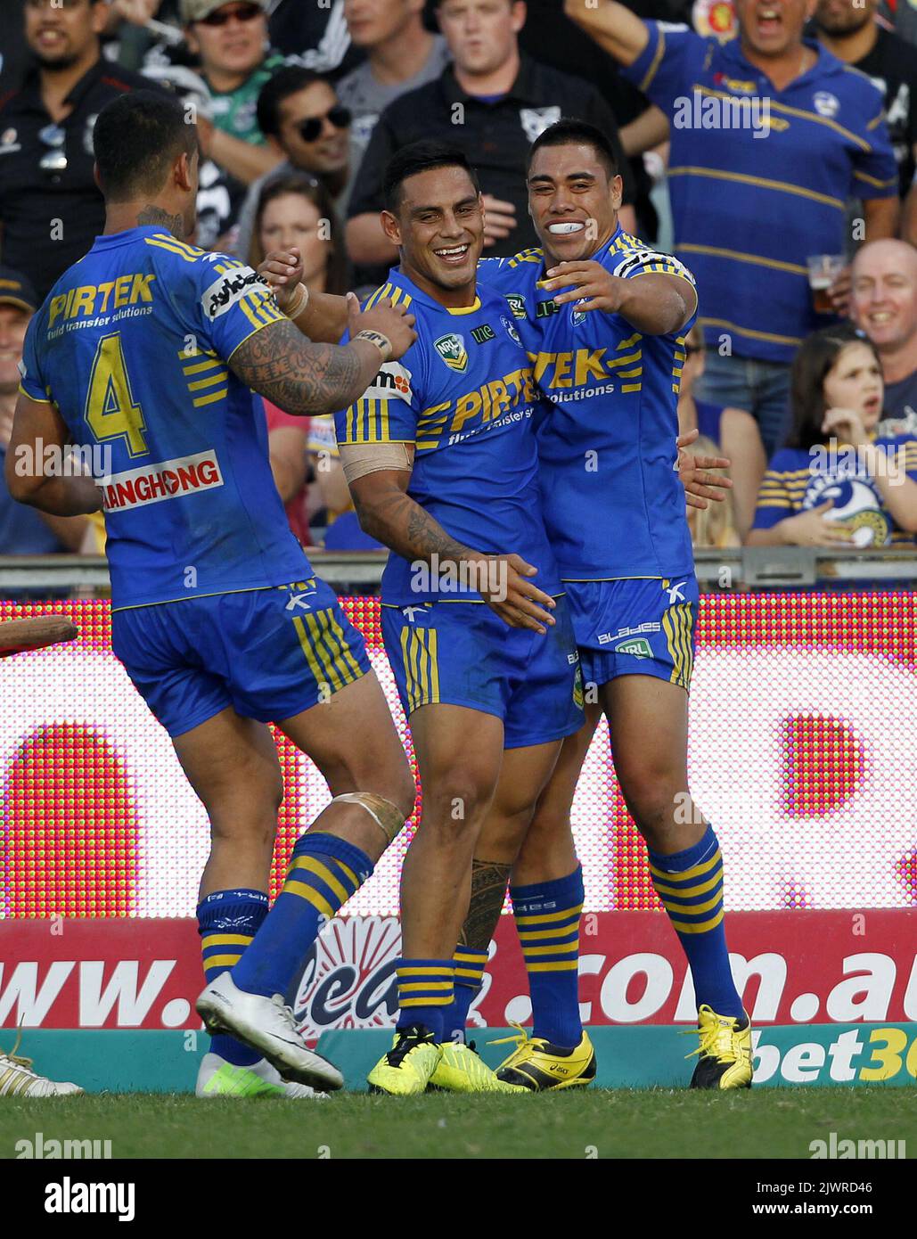 Reni Maitua and Jacob Loko celebrate with try scorer Ken Sio during the ...