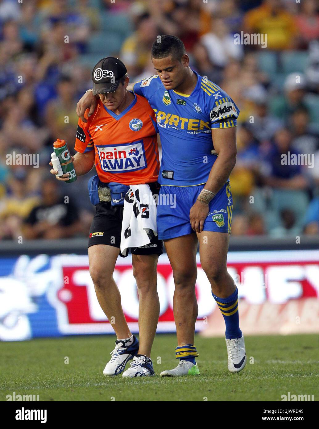 Jacob Loko leaves the field injured with trainer Trent Elkin during the ...