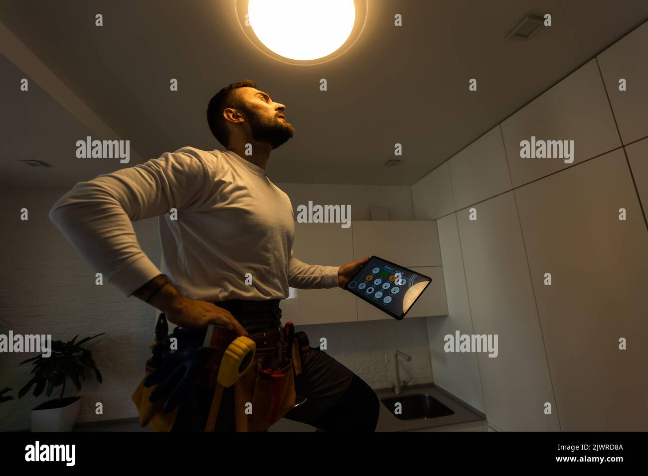 electrician installing led light bulbs in ceiling lamp Stock Photo - Alamy