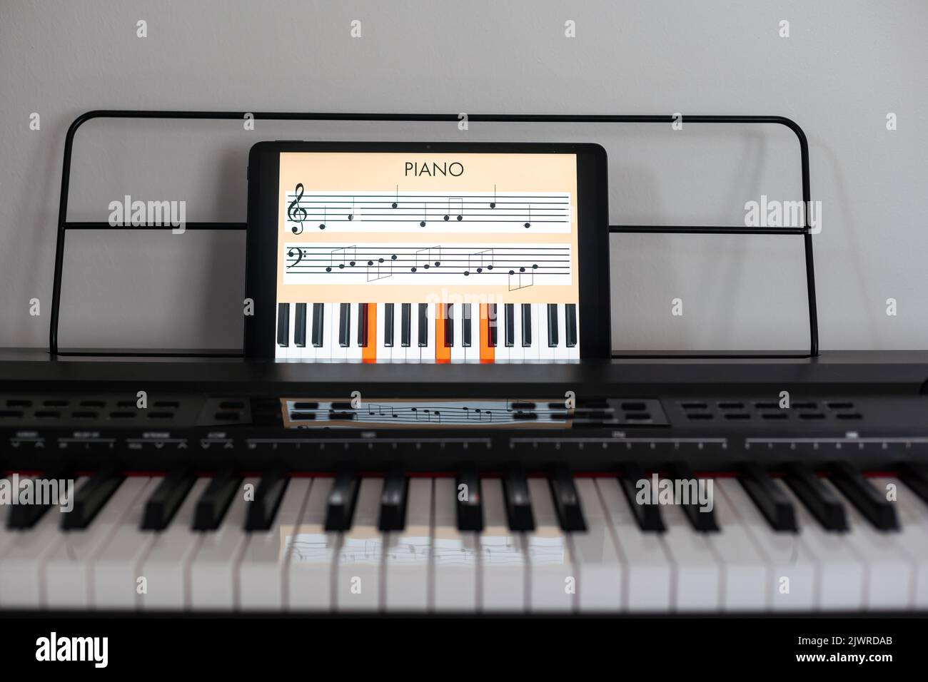 Piano synthesizer app on tablet and musical instrument concept Stock ...