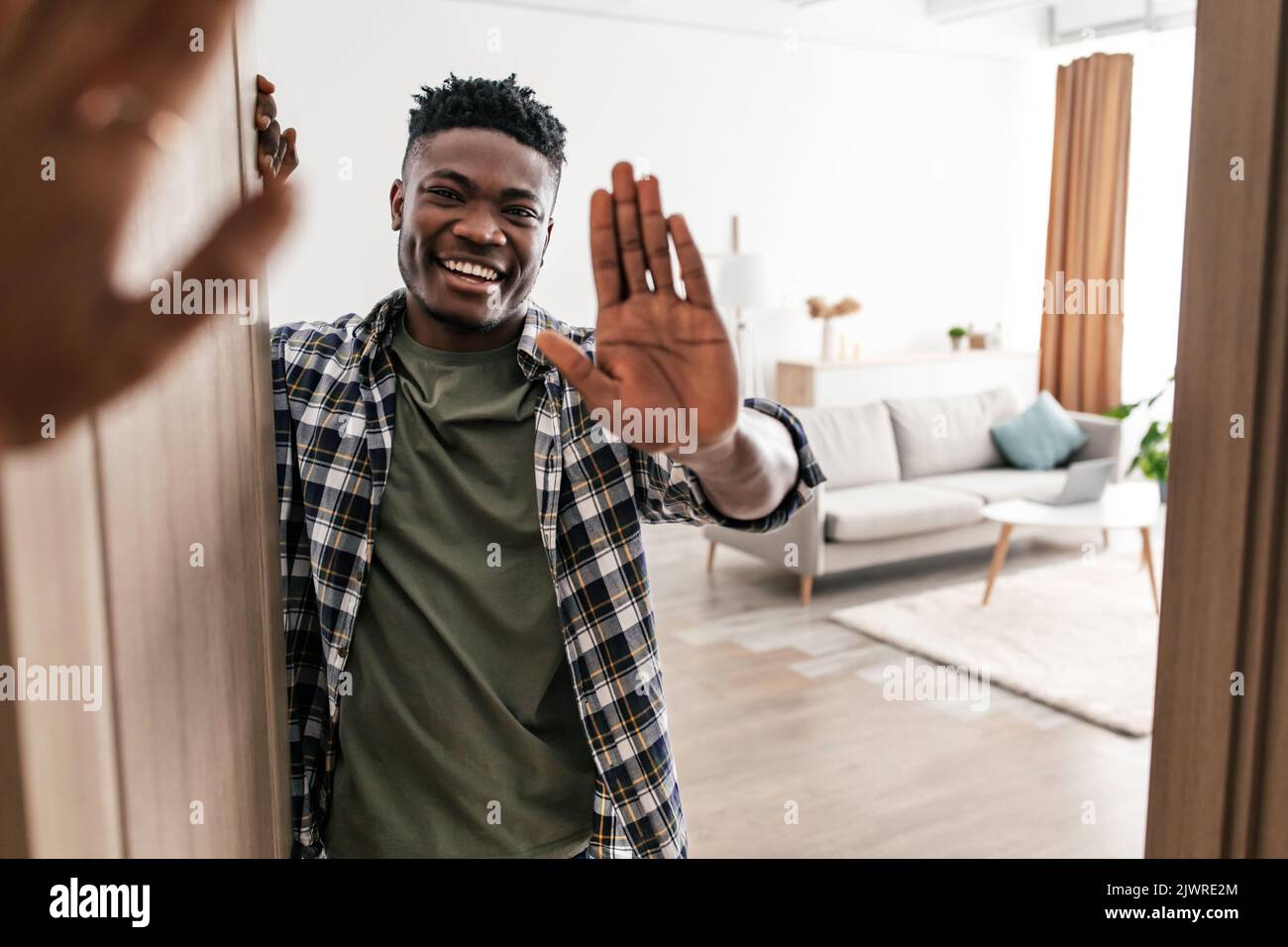 Black Man Waving Hand Opening Door Of House Standing Indoor Stock Photo ...