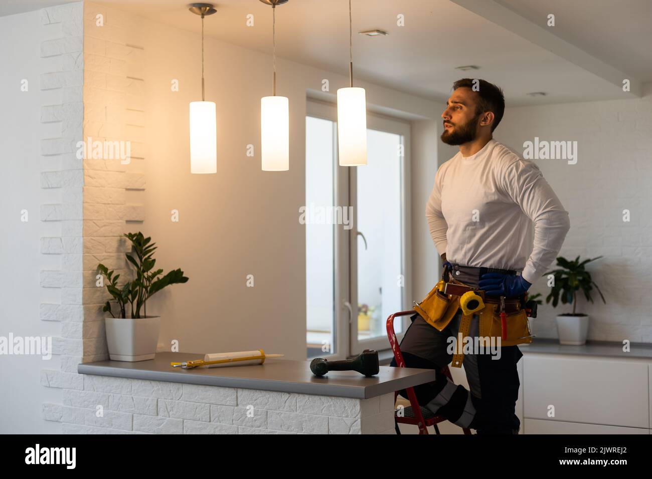 electrician installing led light bulbs in ceiling lamp Stock Photo - Alamy