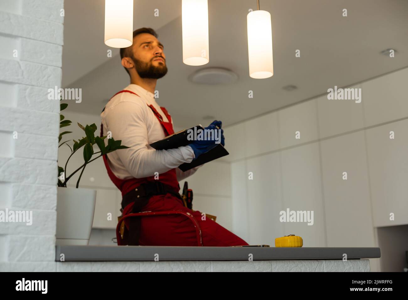 Portrait of an electrician using his tablet computer Stock Photo - Alamy