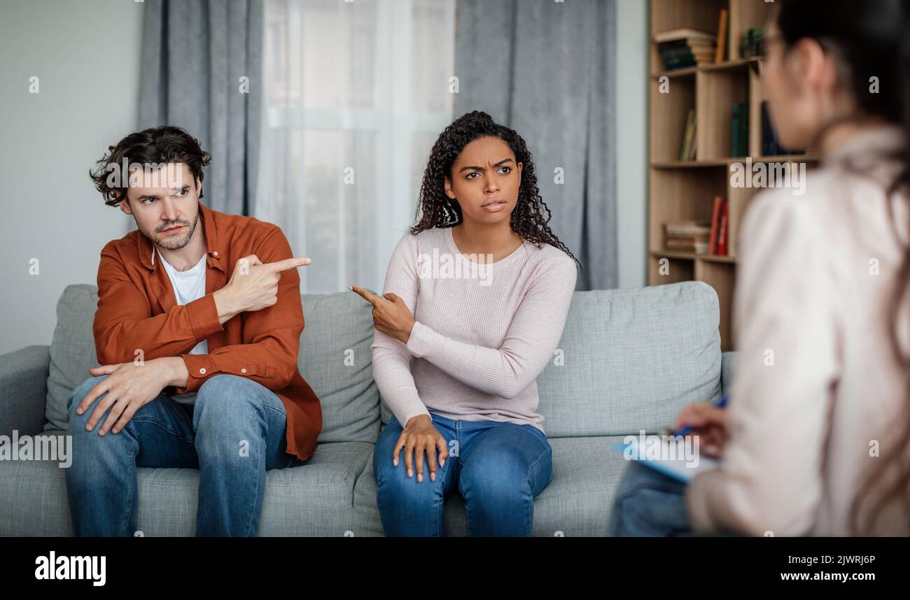 Offended sad millennial black female pointing finger at european man on ...