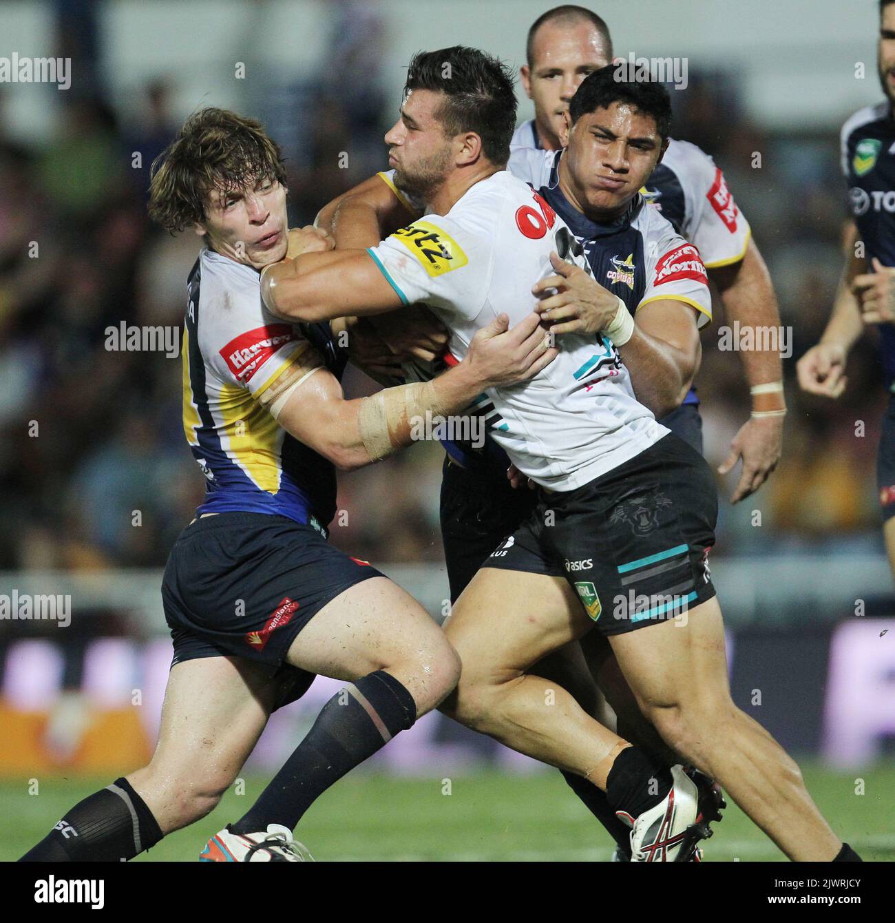 Josh Mansour tackled by Rory Kostjasyn and Jason Taumalolo during the ...