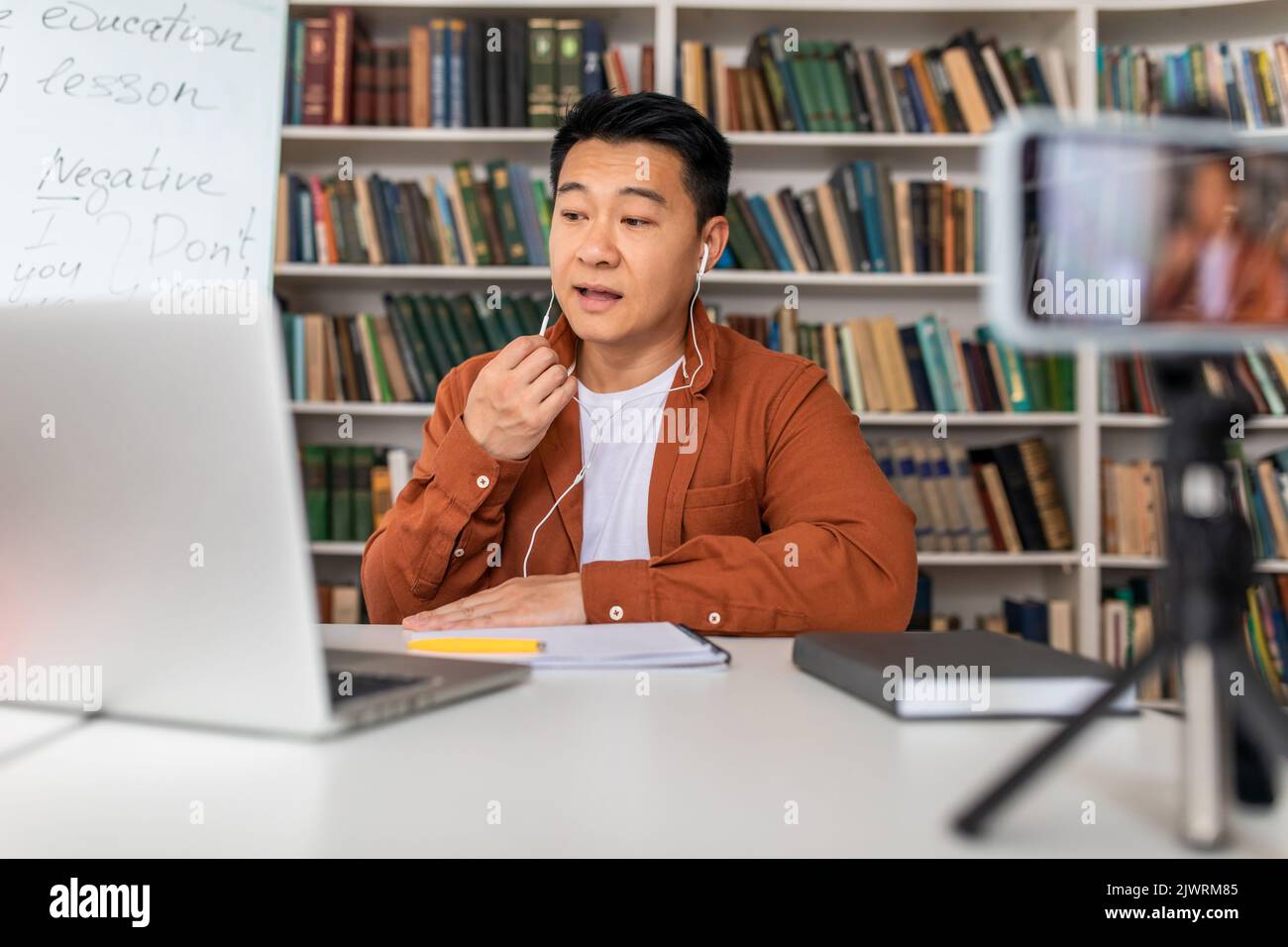 Korean Tutor Having Online Lecture Talking To Laptop At Workplace Stock ...