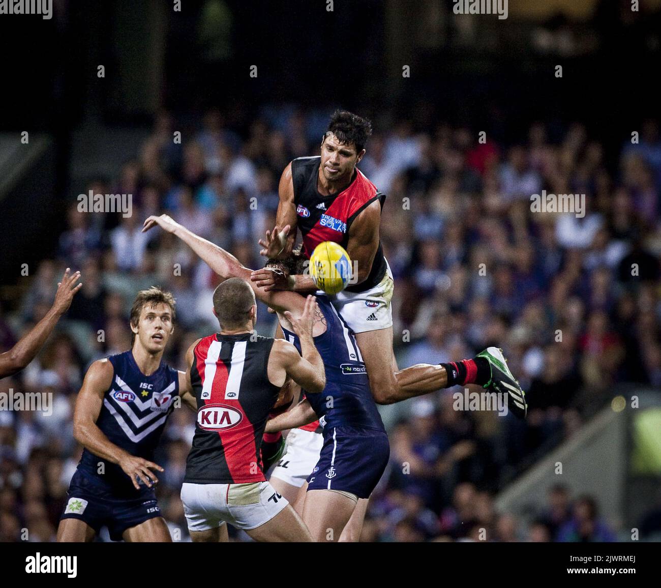 Patrick Ryder of Essendon over the top of Jonathon Griffin of Fremantle ...