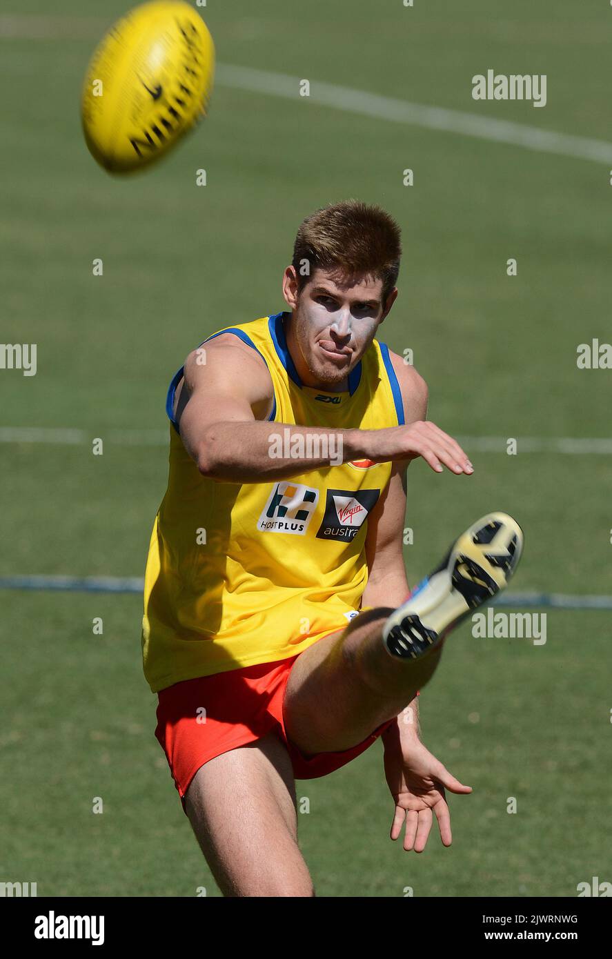 Zac Smith kicks a ball during the Gold Coast Suns training session at ...