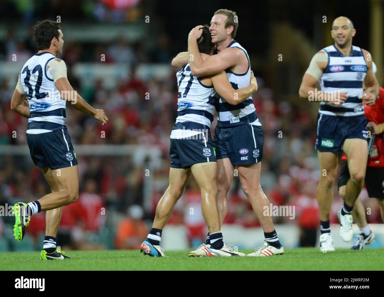 Geelong's Steve Johnson hugs Mathew Stokes after Stokes kicked a goal ...