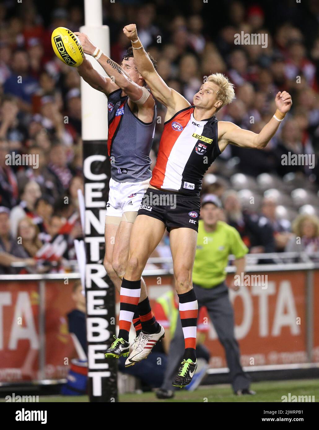 Jake Carlisle goes up for the ball for Essendon against Nick Riewoldt ...