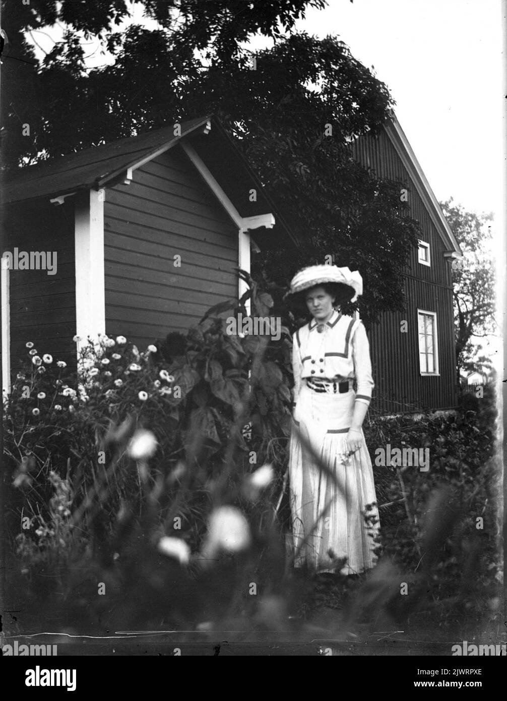 Elna Brundin in Hemling gate. She poses in front of a playhouse on the ...