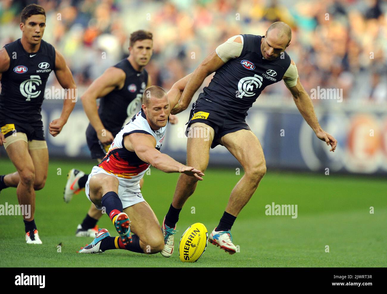 Chris Judd of Carlton tackles Scott Thompson of Adelaide during their ...