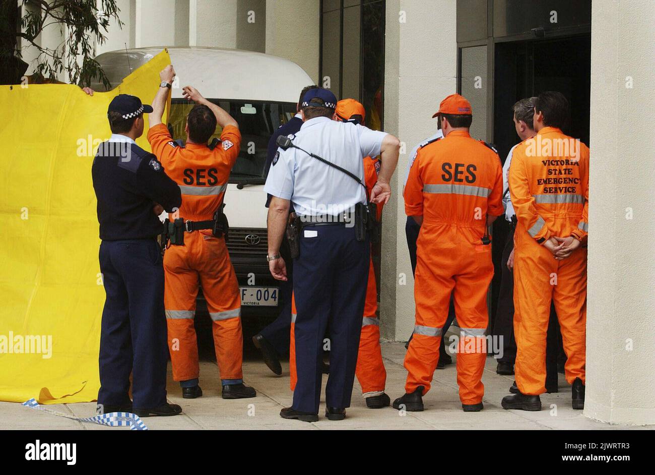 PA PHOTOS/AAP - UK USE ONLY : Police and SES crew cover a van carrying ...