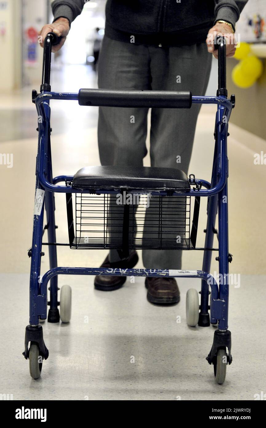 A man uses a walker to assist his mobility in Canberra, Friday, May 24 ...