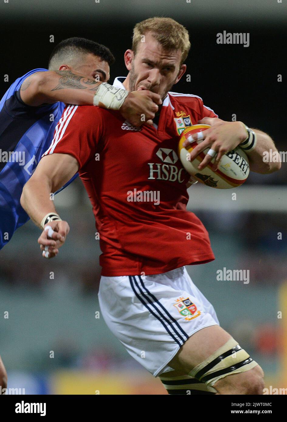 British and Irish Lions' Tom Croft (right) is tackled by Western Force ...