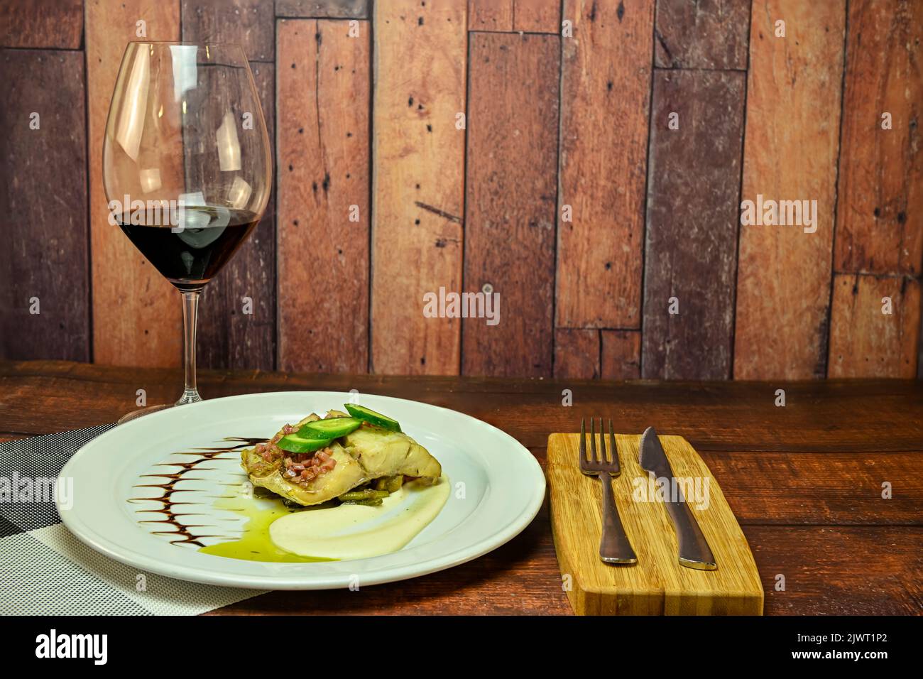 Oven roasted sea bass with ham and cucumber Stock Photo - Alamy