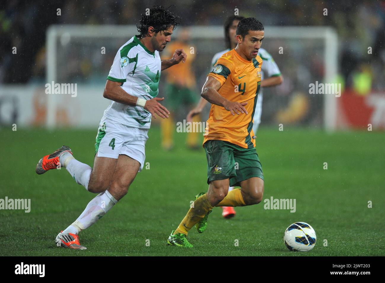 Australia's Tim Cahill and Iraq's Khaldoun Ibrahim (left) battle for ...