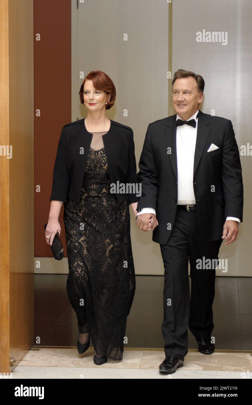 Prime Minister Julia Gillard and Tim Mathieson arrive for the Midwinter ...