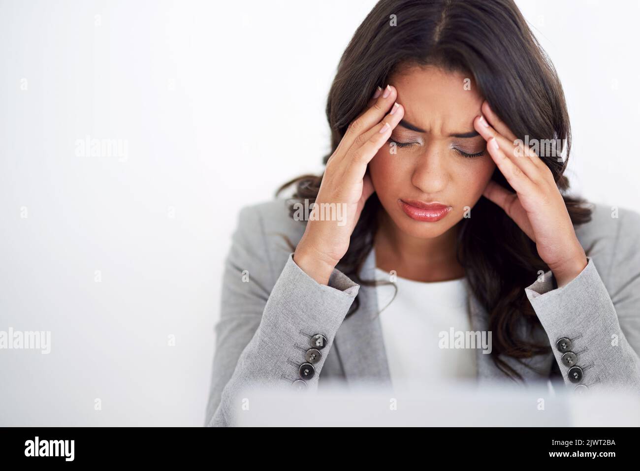 Work can be stressful. a young businesswoman looking stressed while ...