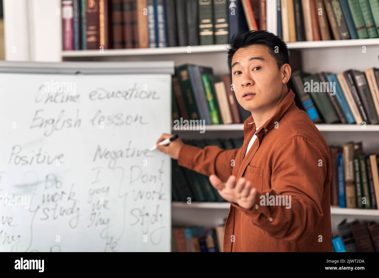 Korean Teacher Man Teaching Looking At Camera In Modern Classroom Stock ...