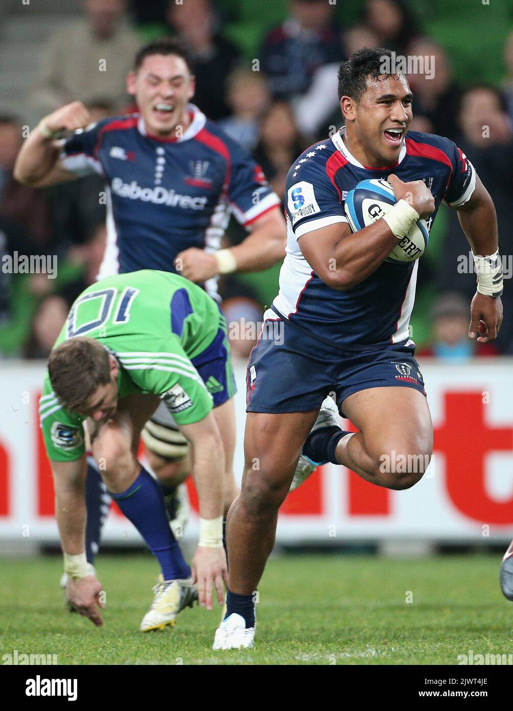 Cooper Vuna of the Rebels is all smiles as he runs to the try line ...