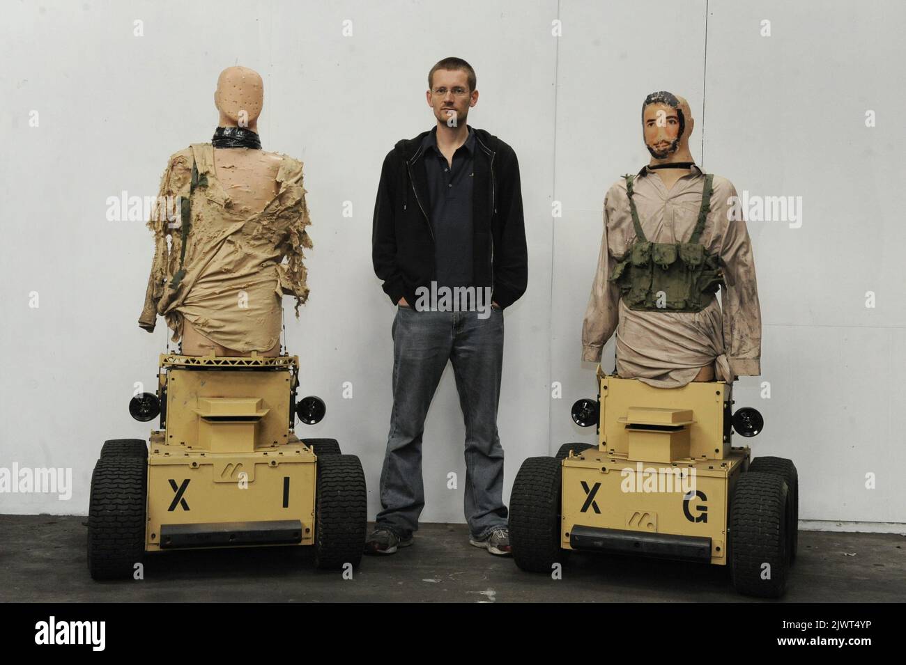 Marathon Targets Director Alex Brooks poses with robotic targets at his ...