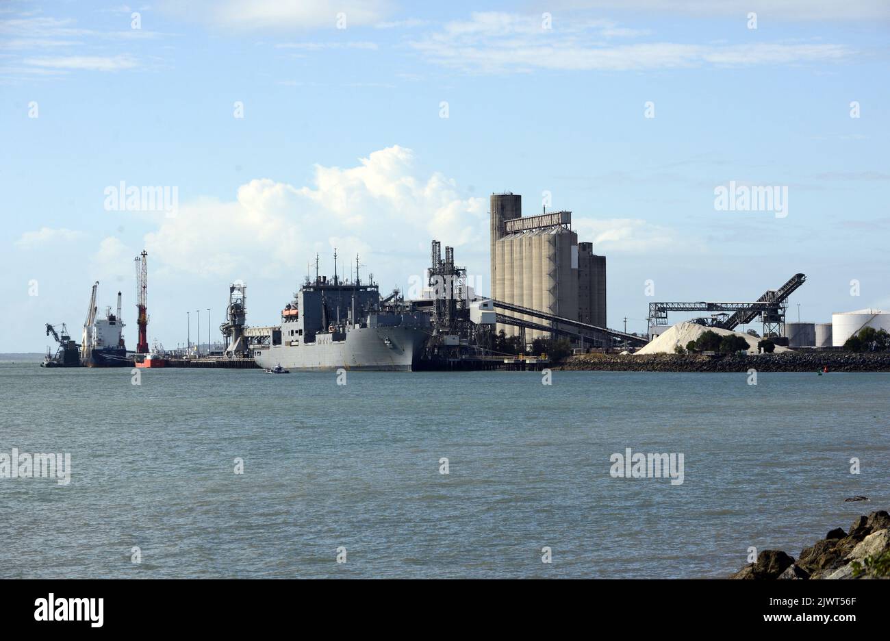 A ship is being loaded at a cement terminal in Gladstone, Queensland ...