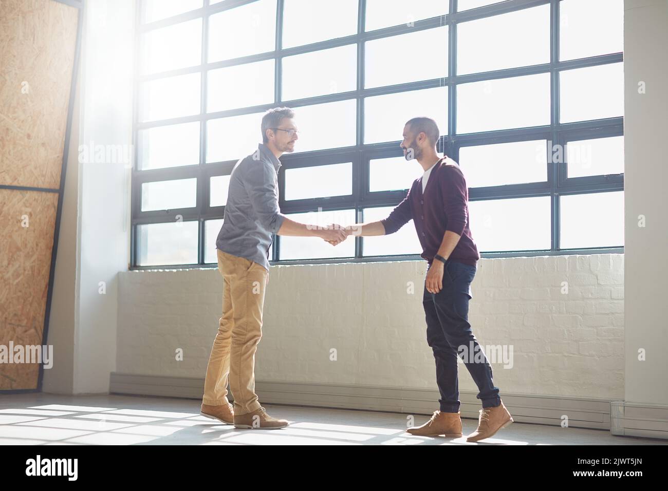 Congratulations, youre hired. two businessmen shaking hands in the ...