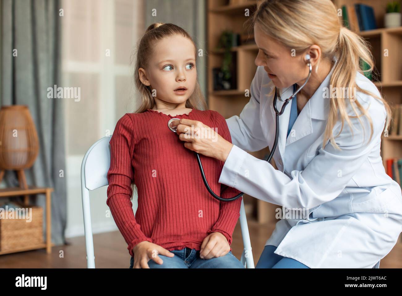 Professional kids medicare. Female pediatrician listening little scared ...