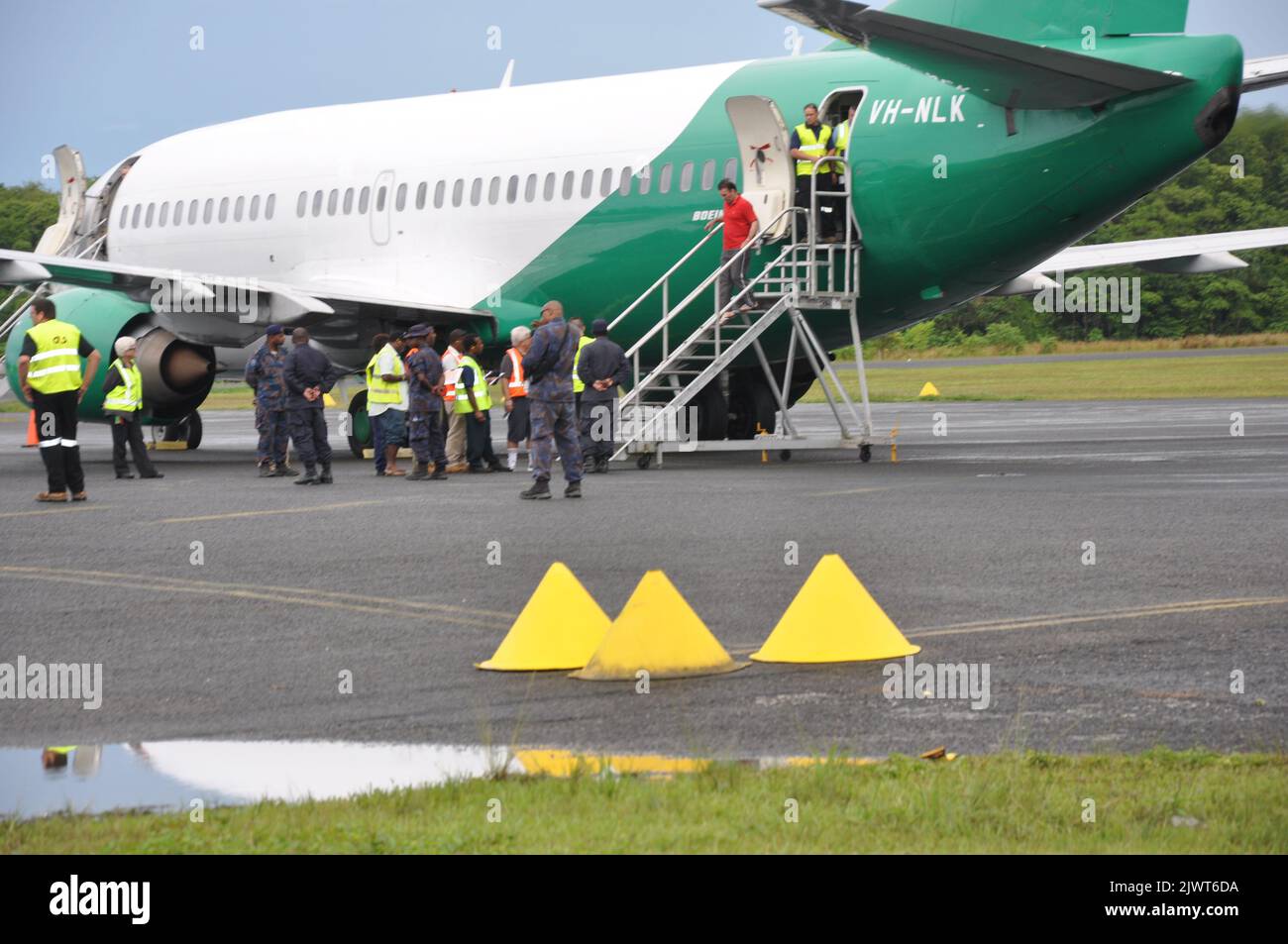 An asylum seeker is lead off a plane on Manus island. From Iran, he ...