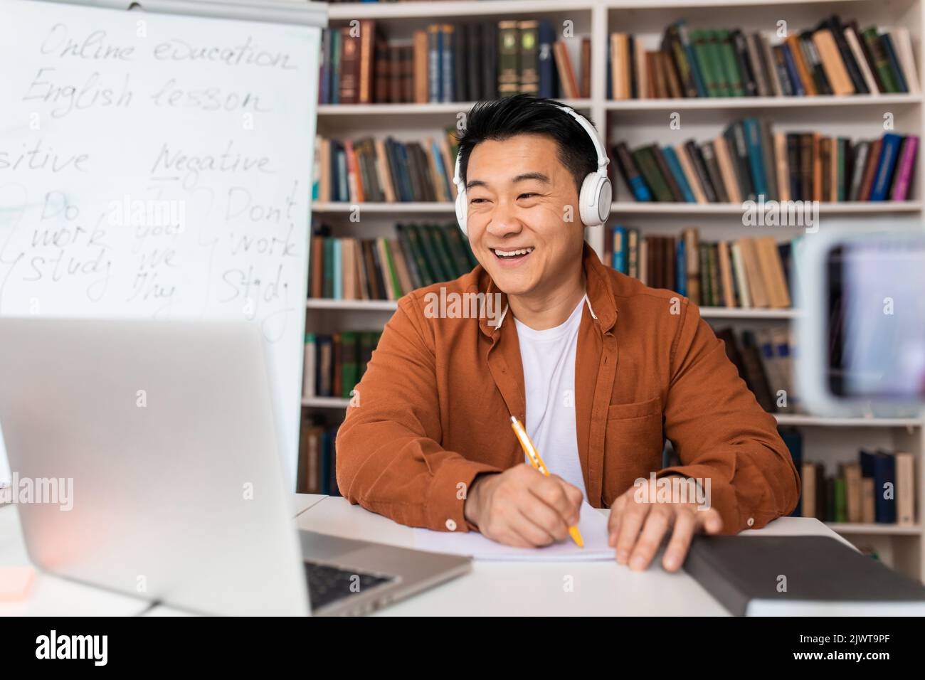 Chinese Teacher Taking Notes Teaching Online Via Laptop At Workplace ...