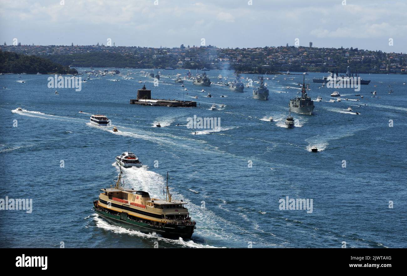 A Sydney ferry makes way across the harbour as the Royal Australian ...