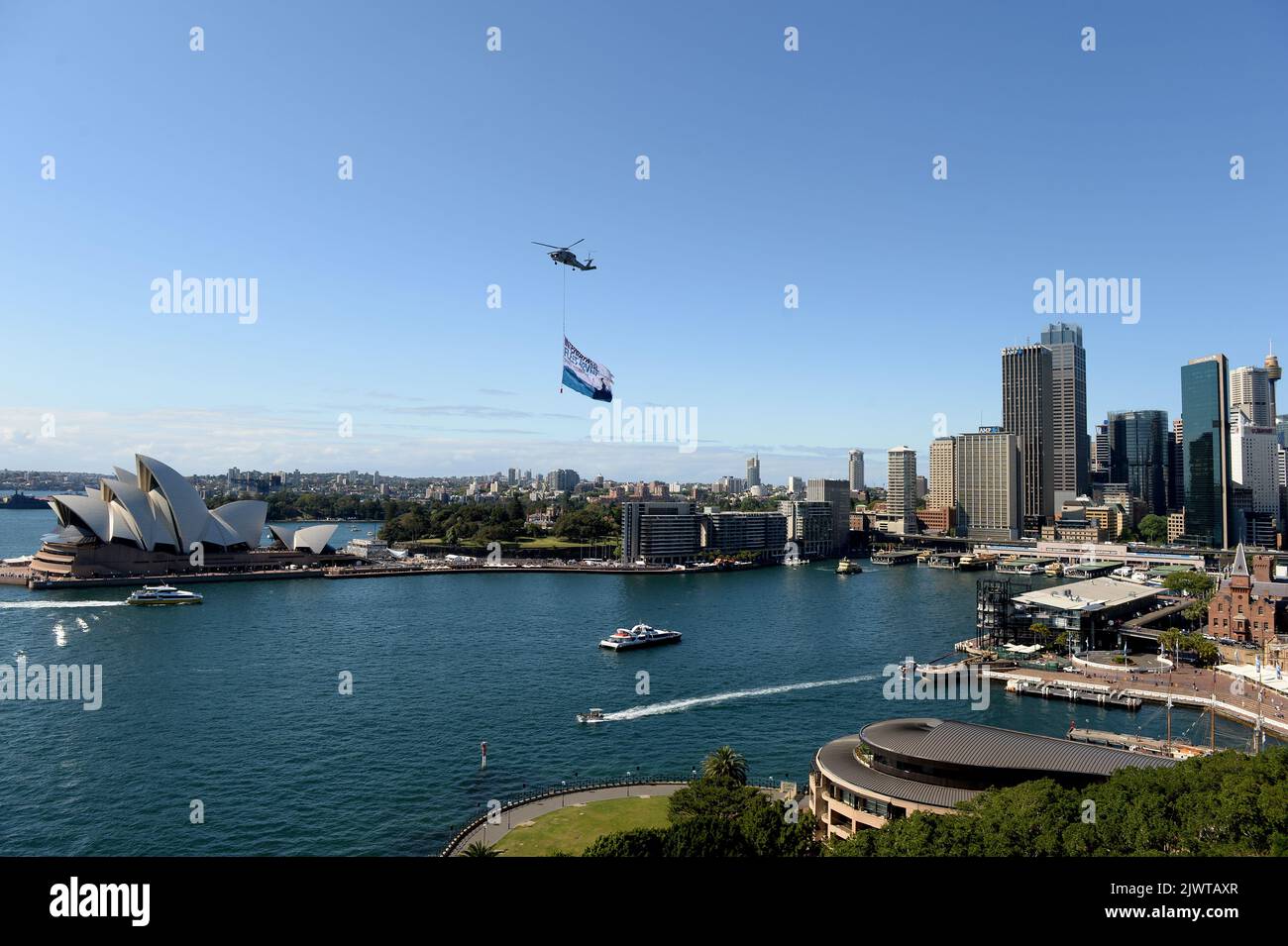 A Royal Australian Navy Seahawk helicopter flies the International ...