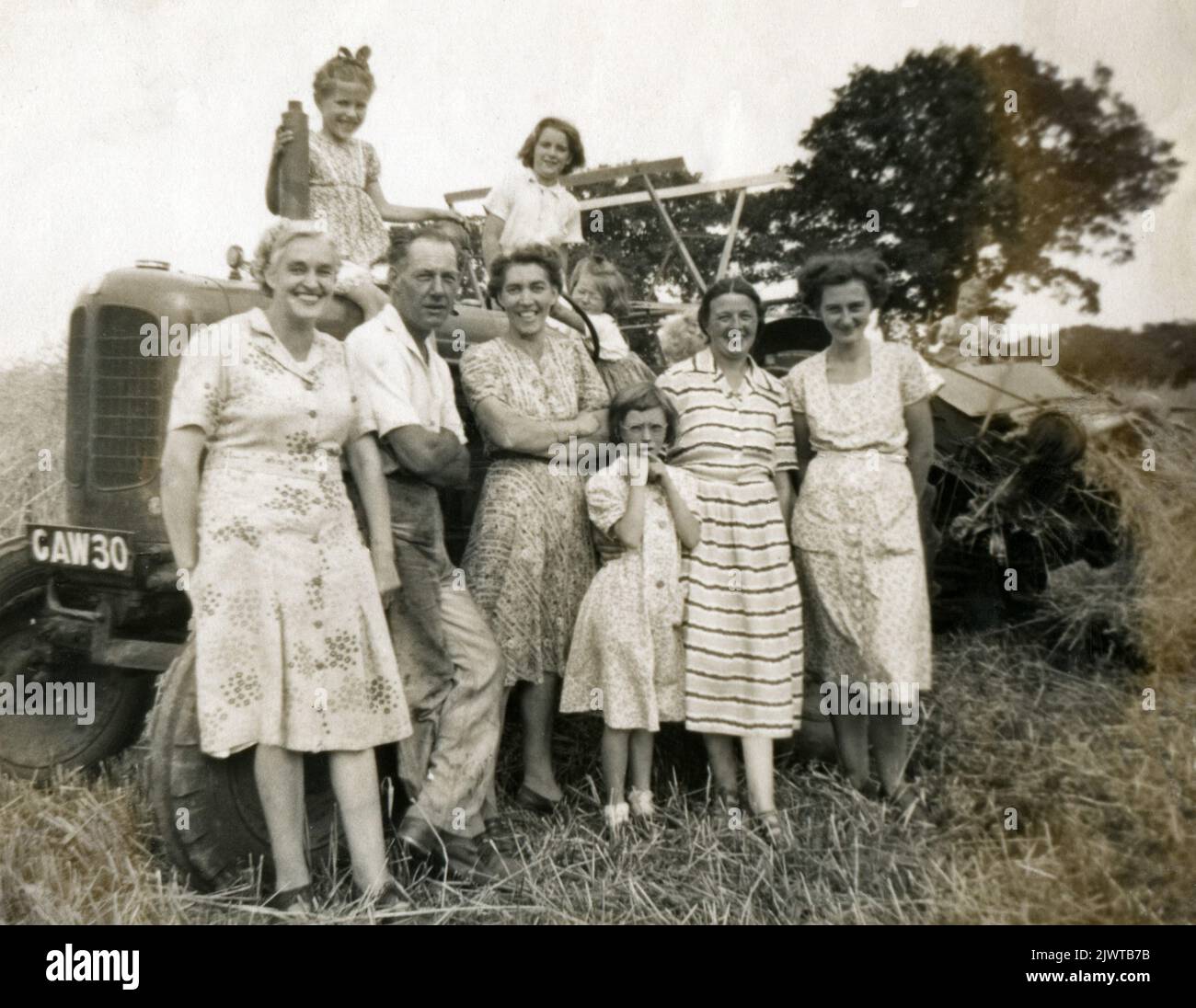 England, 1950s. A cheerful farming family pose for a photograph with ... England, 1950s. A cheerful farming family pose for a photograph with ...