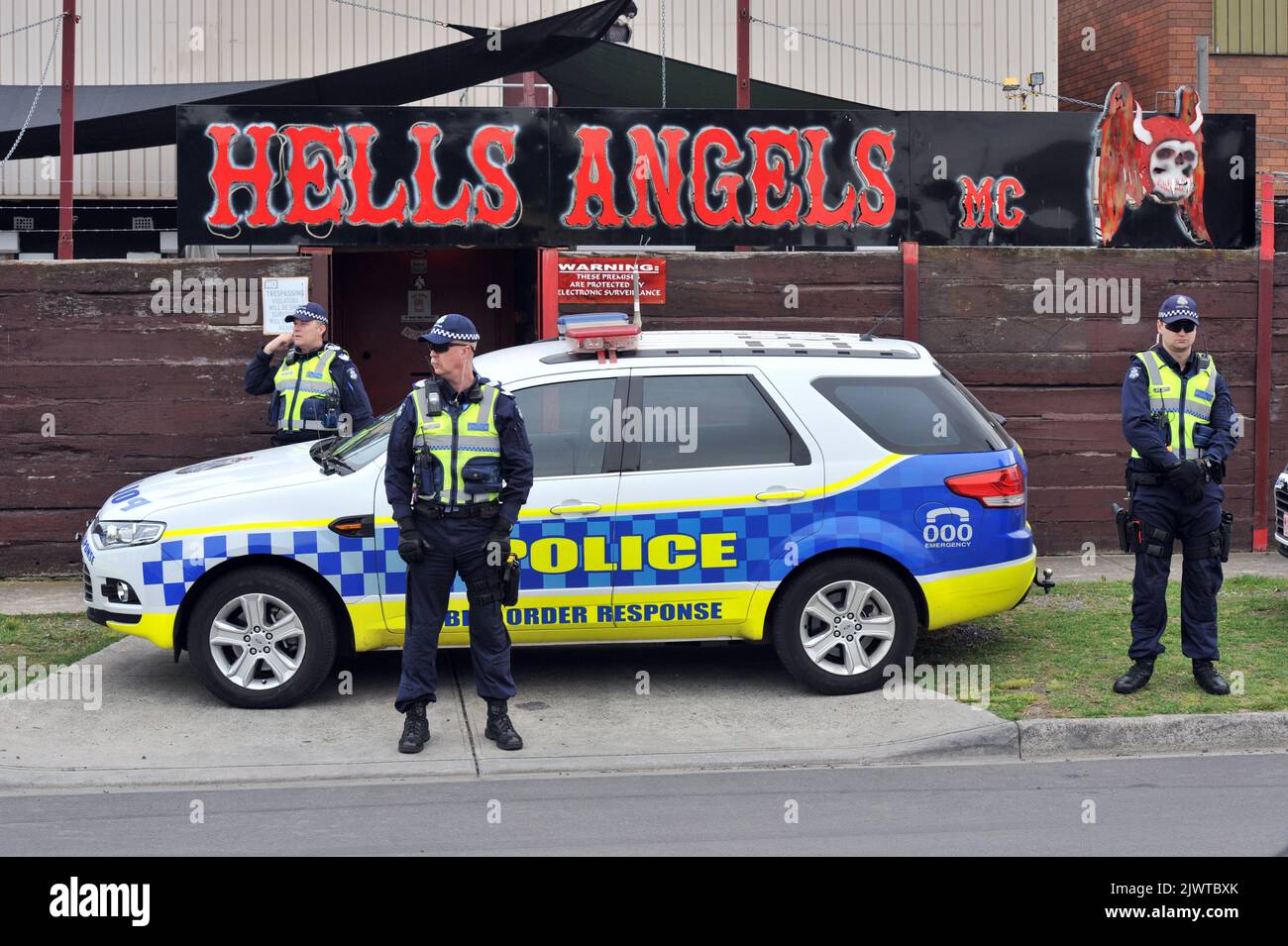 Police stand guard outside a Hells Angels fortified club house in ...