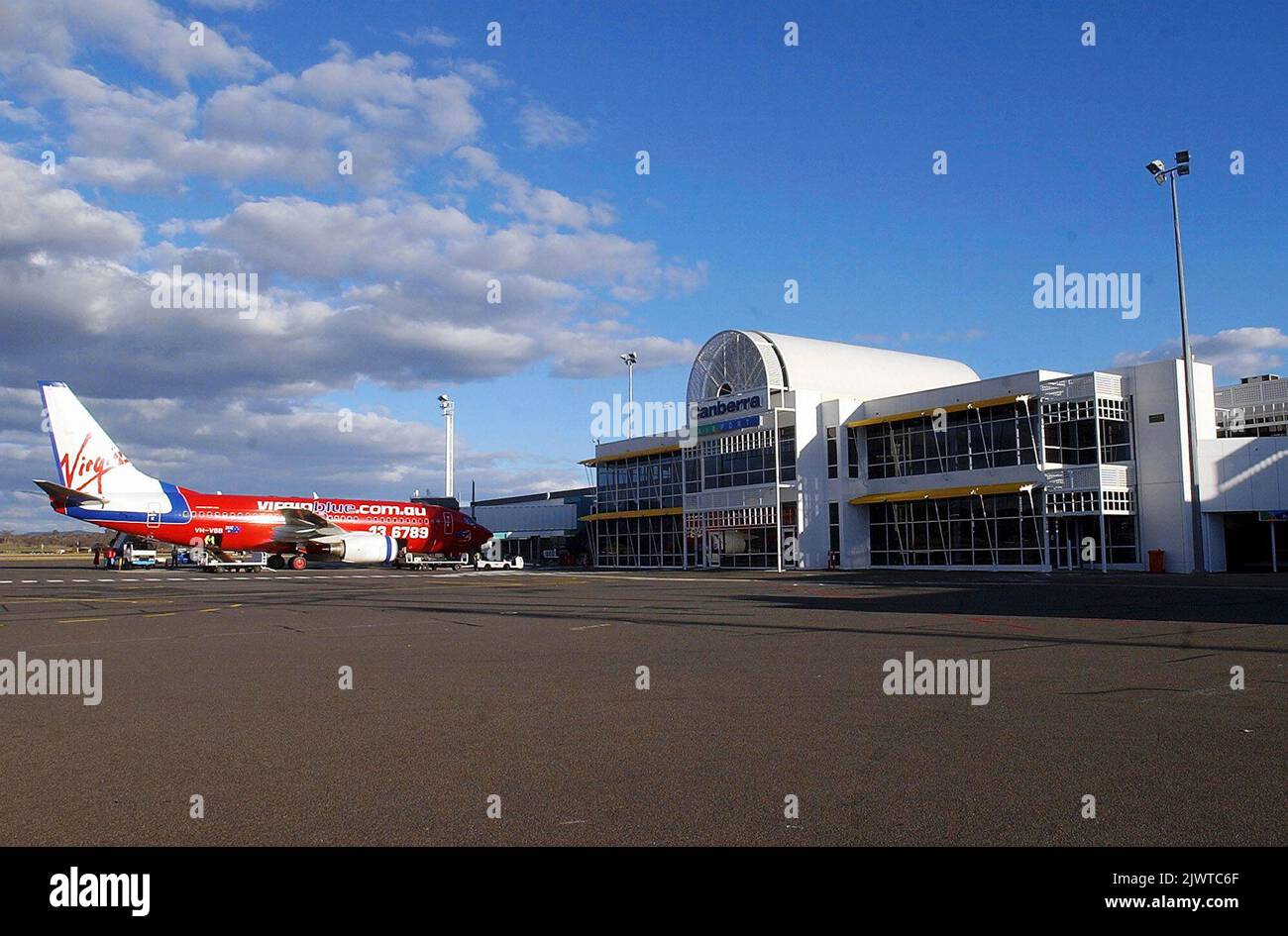 A Virgin Blue aeroplane stands at the flight apron at Canberra Airport ...