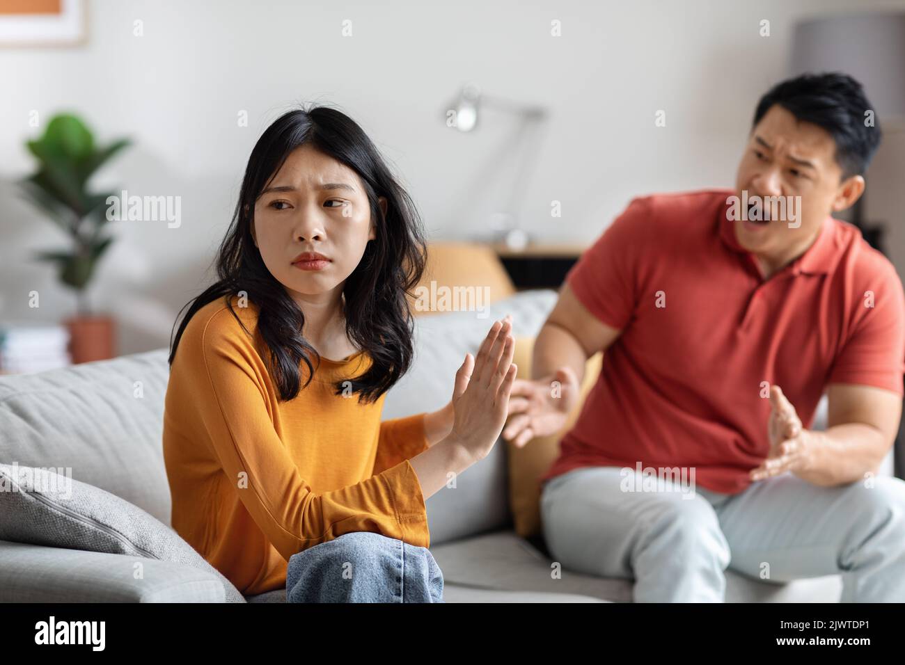 Angry asian husband yelling at his upset wife Stock Photo - Alamy