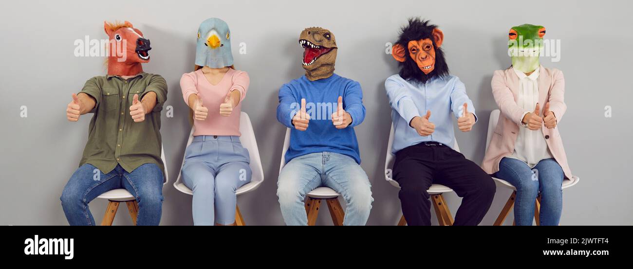 Group of happy strange men and women wearing funny animal masks showing ...