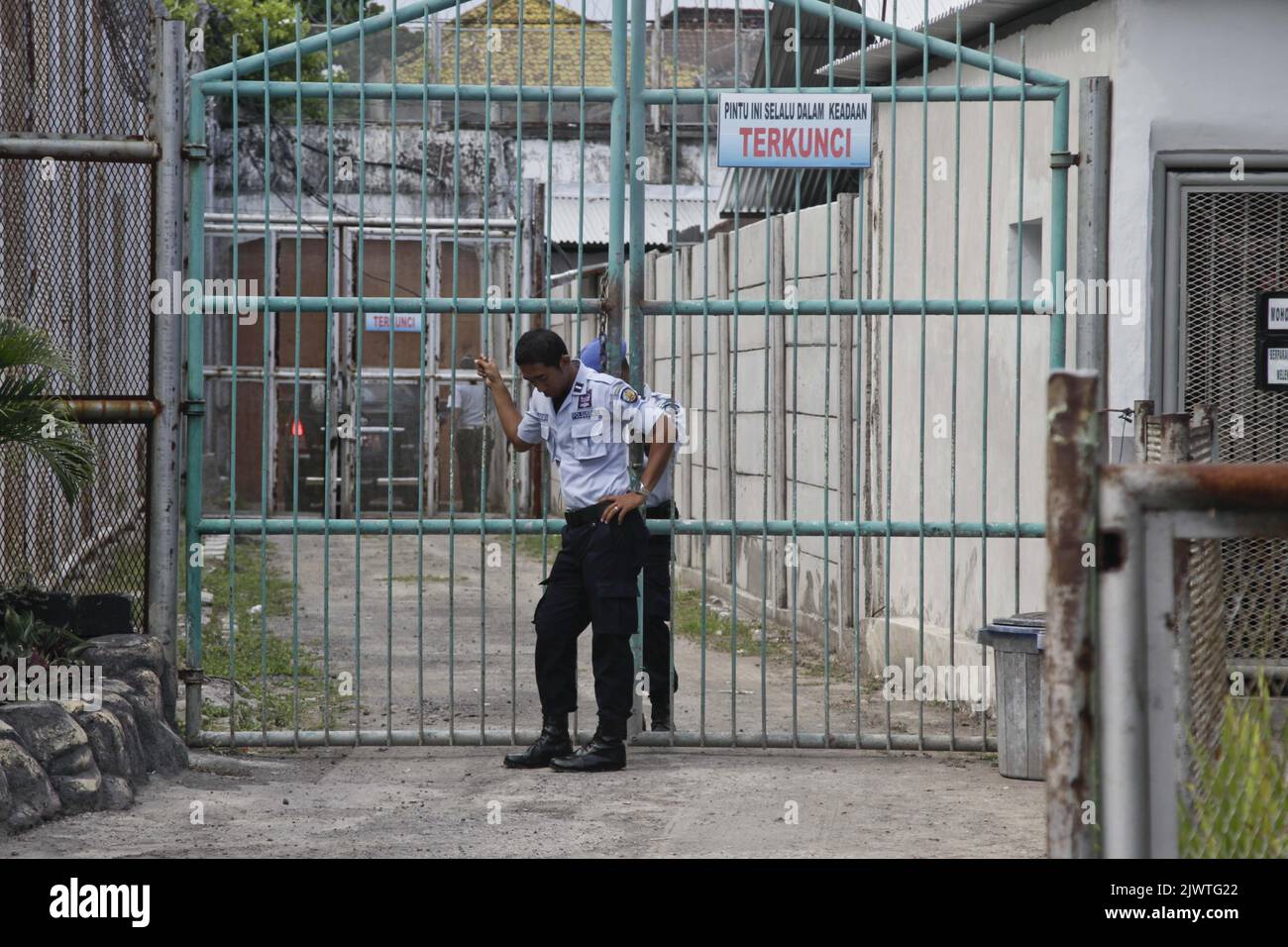 A prison staffer guards the main gate inside the Kerobokan Prison in ...