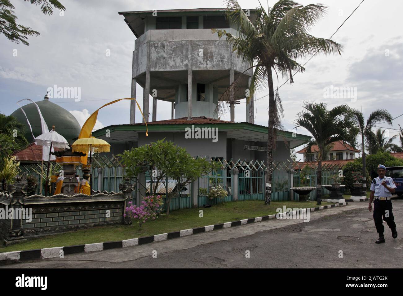 A prison guard patrols in front of the maximum security cell block ...