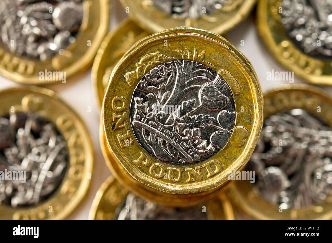 Close up view of the face of a British one pound coin, withother coins ...