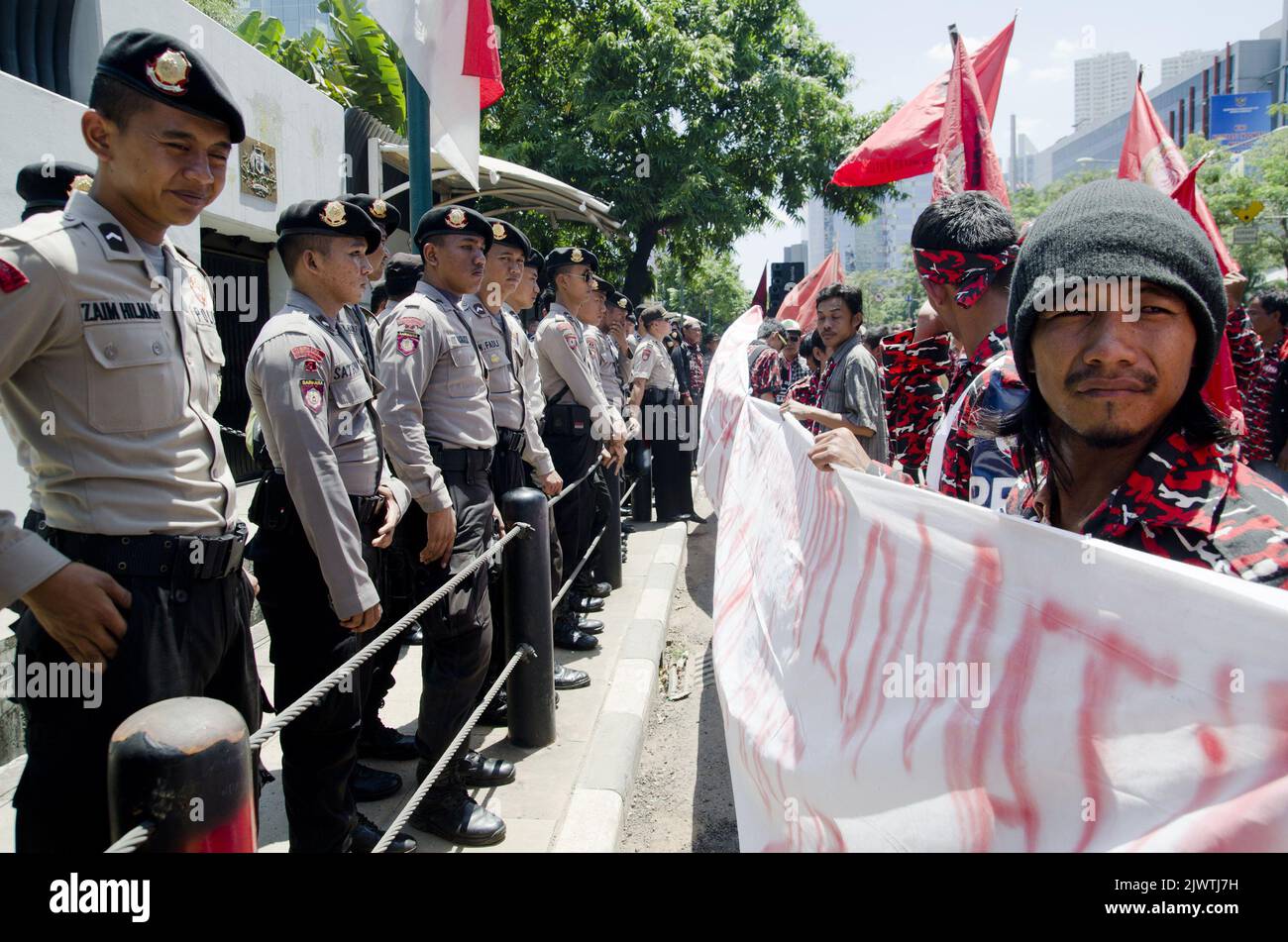 Police guard standing face to face with the protestors from outside of ...