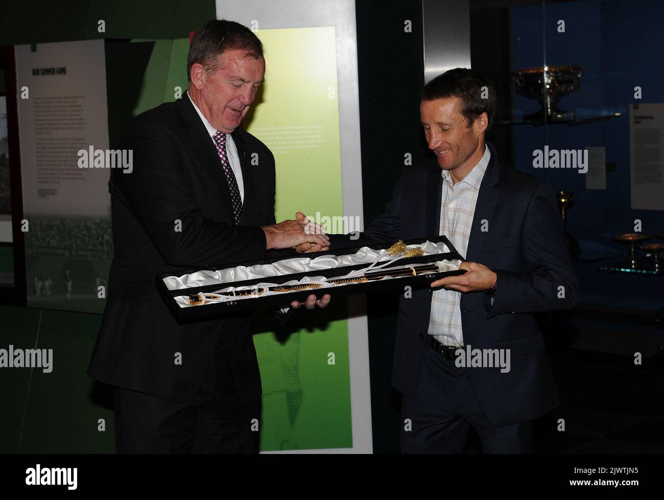 Melbourne Cup winning jockey Damien Oliver (right) is presented the ...