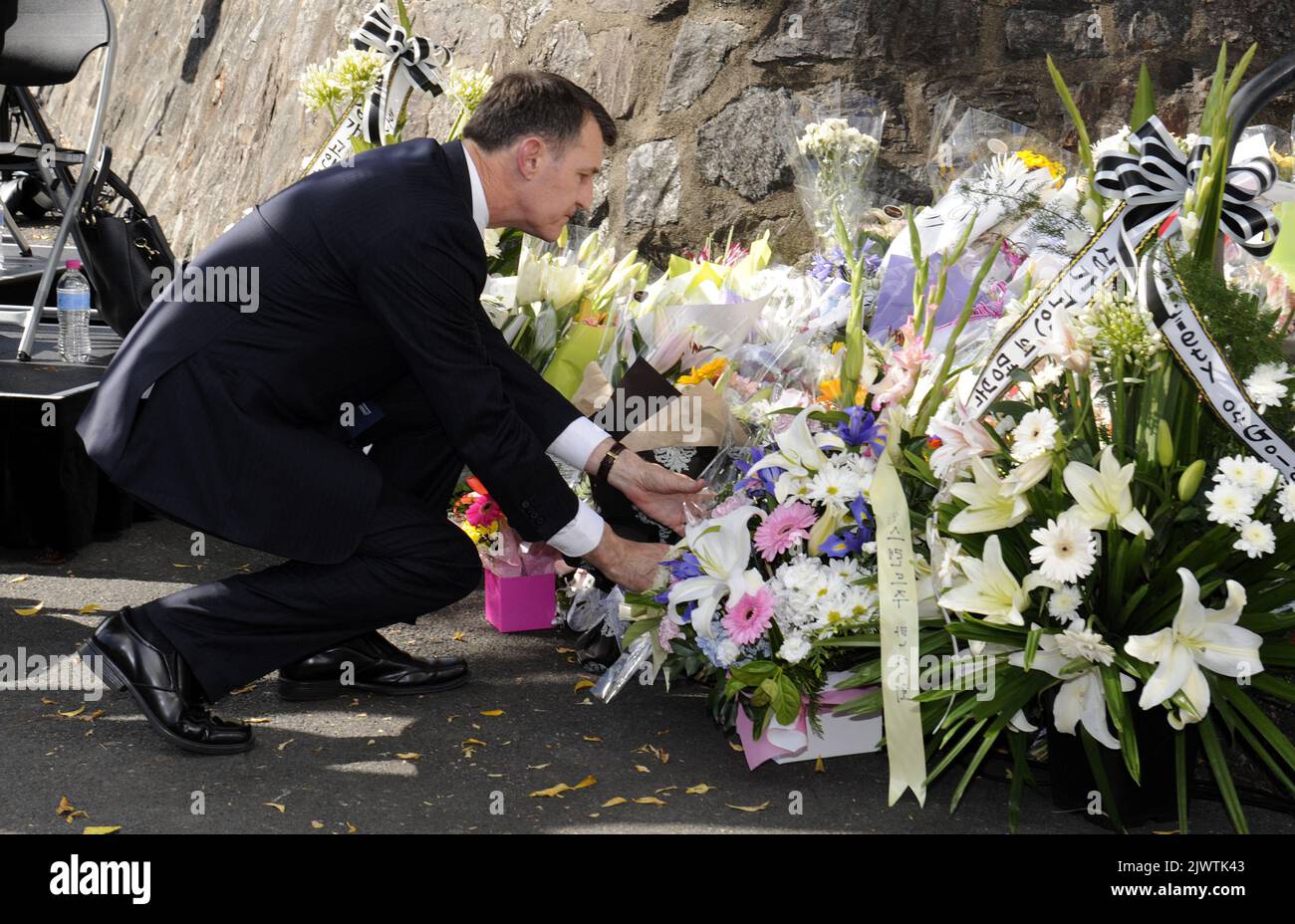 Brisbane Lord Mayor Graham Quirk places flowers during a memorial ...