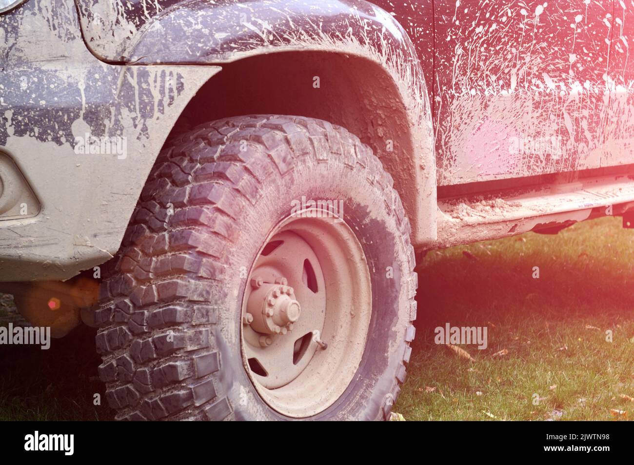SUV covered in mud. The wheels and body of the car are splattered with ...